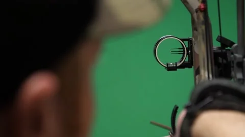 Bowhunter aiming his archery bow on a gr... | Stock Video | Pond5