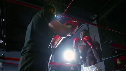 Boxer practicing punching with trainer o... | Stock Video | Pond5