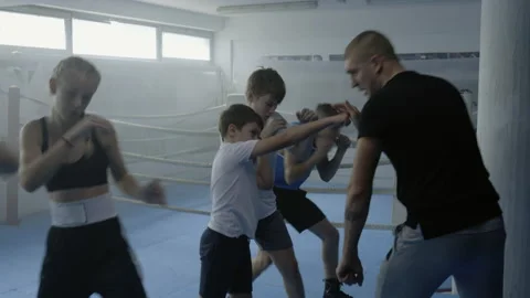 Boxing teacher showing kids punches tech... | Stock Video | Pond5
