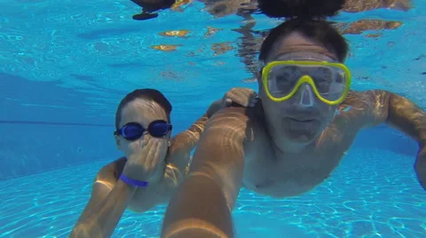 Boy and father diving in swimming pool. ... | Stock Video | Pond5