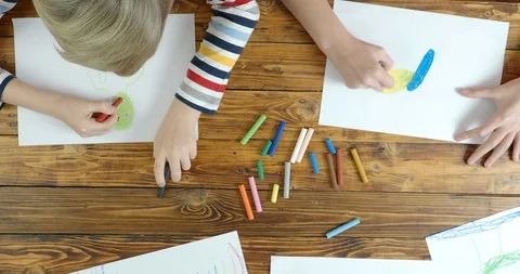 Boy and girl drawing by pastel on paper,... | Stock Video | Pond5