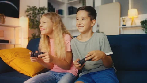 Boy and girl gaming buddies enjoying vid... | Stock Video | Pond5