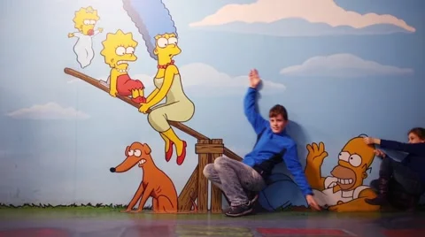 Boy and girl poses with Simpsons in opti... | Stock Video | Pond5