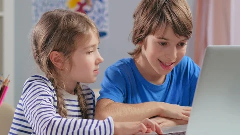 Boy and girl watching cartoons on laptop... | Stock Video | Pond5
