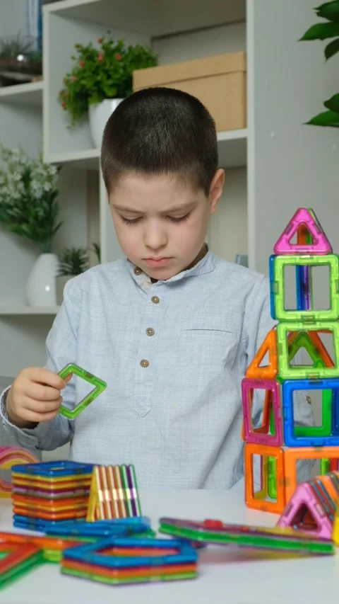 Boy building a tower from a magnetic con... | Stock Video | Pond5