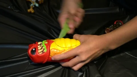 Boy cutting open an Alien from a "Treasu... | Stock Video | Pond5