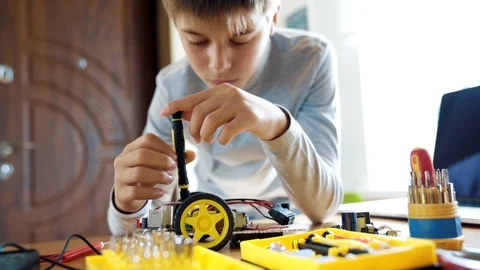 The boy designs an electronic toy model.... | Stock Video | Pond5