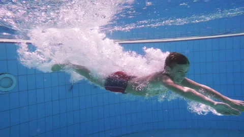 Boy dive in swimming pool | Stock Video | Pond5