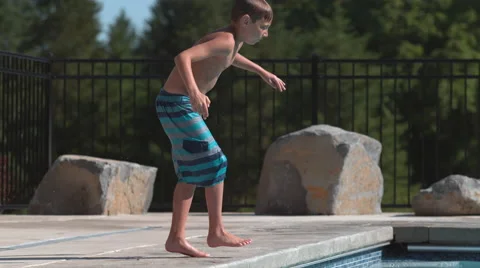 Boy doing a flip into pool in super slow... | Stock Video | Pond5