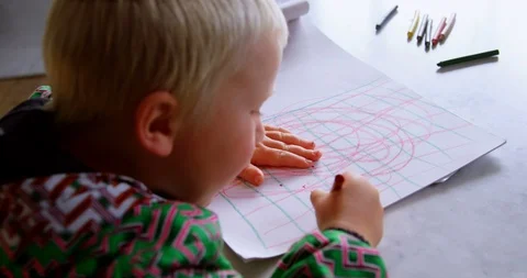 Boy drawing with crayons on paper at hom... | Stock Video | Pond5