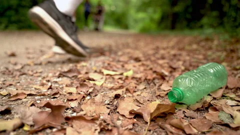 Boy during a run he stops to collect a p... | Stock Video | Pond5