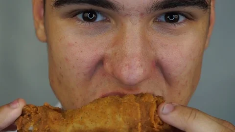 Boy is eating the big crispy chicken fee... | Stock Video | Pond5