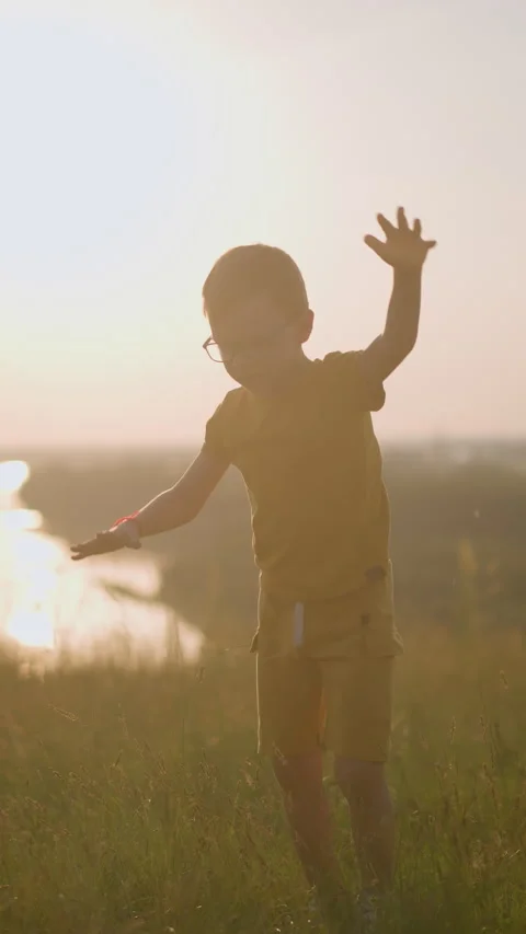 Boy Flipping in a Sunset Field with a La... | Stock Video | Pond5