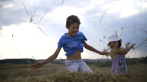 boy with the girl play on haystack havin... | Stock Video | Pond5