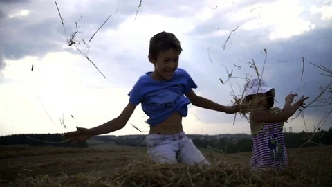 boy with the girl play on haystack havin... | Stock Video | Pond5