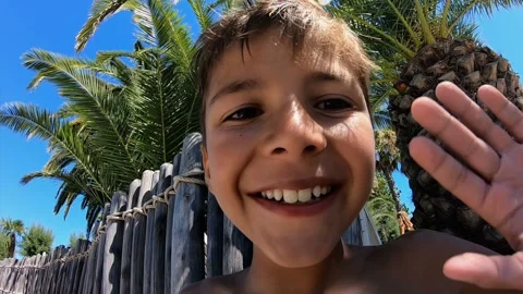 Boy happy smiling on palm tree backgroun... | Stock Video | Pond5
