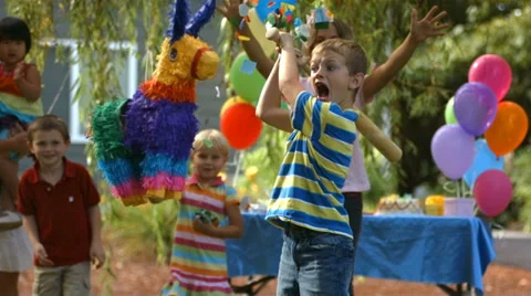 Boy hitting a pinata at party, slow moti... | Stock Video | Pond5