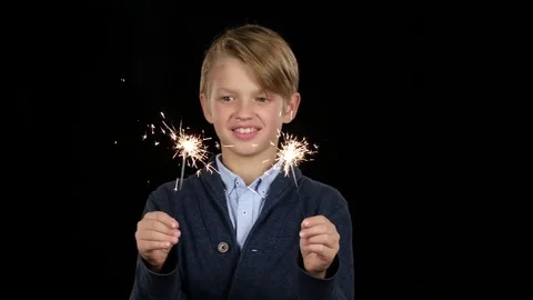 Boy holds a bengal fire in both hands, s... | Stock Video | Pond5