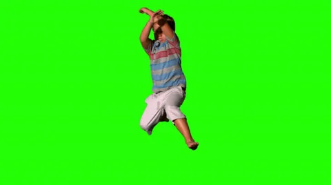 Boy jumping on a green screen | Stock Video | Pond5