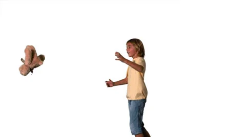 Boy jumping to kick teddy bear on white ... | Stock Video | Pond5