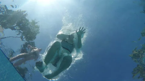 the boy jumps after the girl from the ed... | Stock Video | Pond5