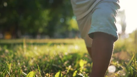 Boy kid run on grass in summer in park. ... | Stock Video | Pond5