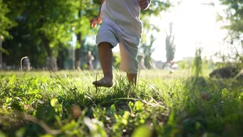 Boy kid run on grass in summer in park. ... | Stock Video | Pond5