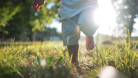 Boy kid run on grass in summer in park. ... | Stock Video | Pond5