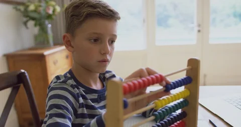 Boy learning mathematics on abacus at ta... | Stock Video | Pond5
