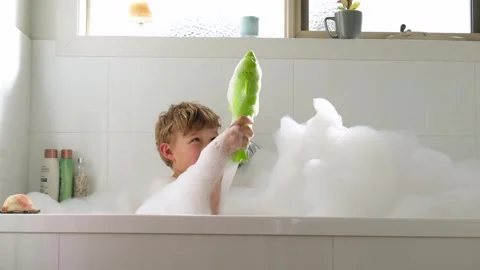 Boy playing with green shark in bubble b... | Stock Video | Pond5