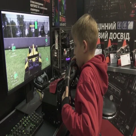 Boy playing race video game on a big scr... | Stock Video | Pond5