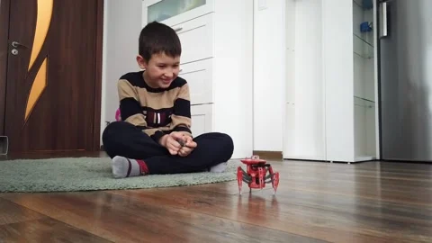 Boy playing with spider robot toy on the... | Stock Video | Pond5