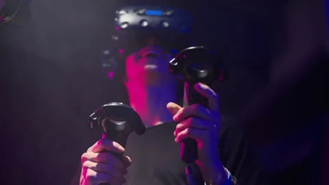 Boy playing VR games in a studio with bl... | Stock Video | Pond5