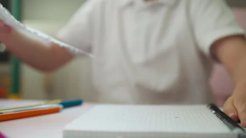Boy pulls to tear out notebook page with... | Stock Video | Pond5