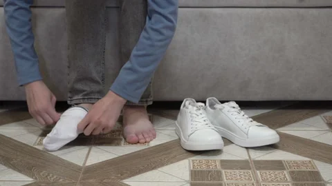 boy put on white socks | Stock Video | Pond5