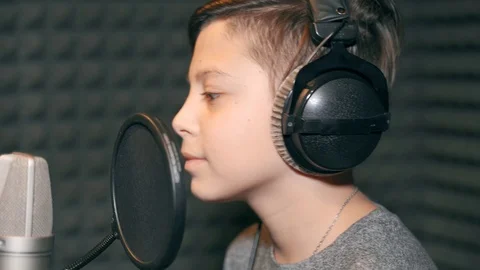 A boy is recording a song in a recording... | Stock Video | Pond5