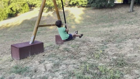 Boy rides on Flying Fox play equipment i... | Stock Video | Pond5