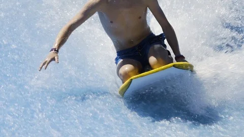 Boy riding wave machine on boogie board ... | Stock Video | Pond5