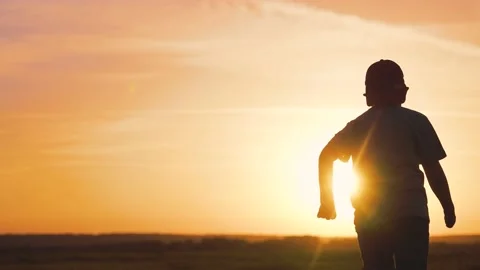 boy run. kid kid running a across the fi... | Stock Video | Pond5