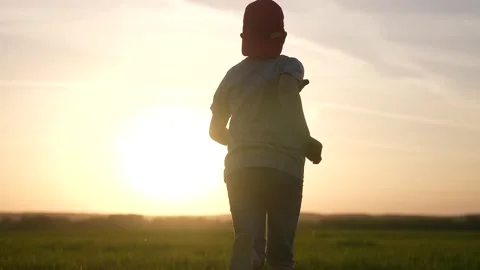 boy run. kid kid running a across the fi... | Stock Video | Pond5