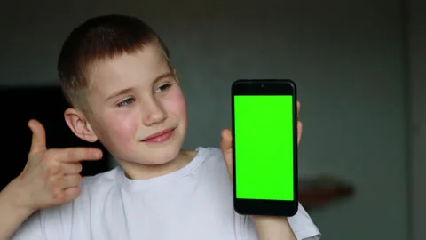 Boy smiling and showing a mobile phone w... | Stock Video | Pond5