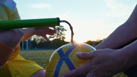 Boy soccer player pumps a ball with his ... | Stock Video | Pond5