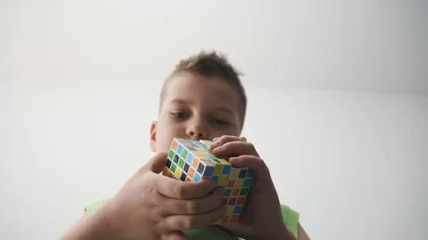 Boy Solving the Rubiks Cube. Young Boy C... | Stock Video | Pond5
