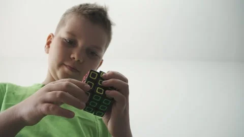 Boy Solving the Rubiks Cube. Young Boy C... | Stock Video | Pond5