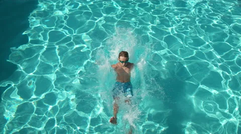 Boy splashing into pool in slow motion, ... | Stock Video | Pond5