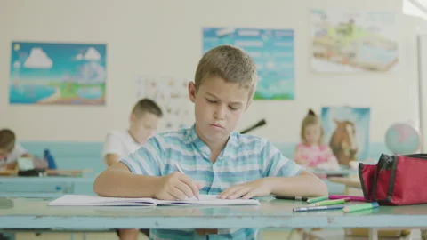 A Boy Student writing in an Exercise Not... | Stock Video | Pond5