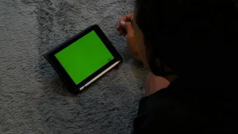 Boy Swipe and Watching A Tablet With A G... | Stock Video | Pond5