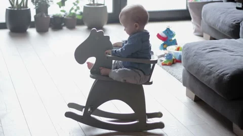 Boy toddler baby swinging on a rocking c... | Stock Video | Pond5