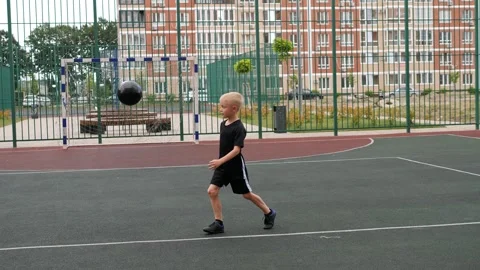 A boy trains with a soccer ball on a rub... | Stock Video | Pond5