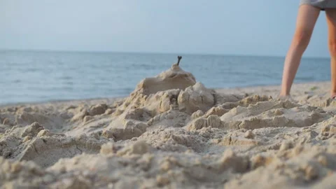 A boy tramples a sand castle on the seas... | Stock Video | Pond5